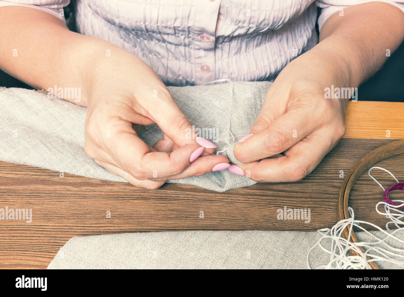 Woman hands doing openwork embroidery on homespun linen. Close up ...
