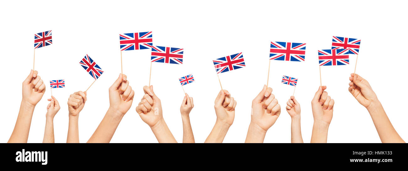 Hands holding and raising flags of Great Britain Stock Photo - Alamy