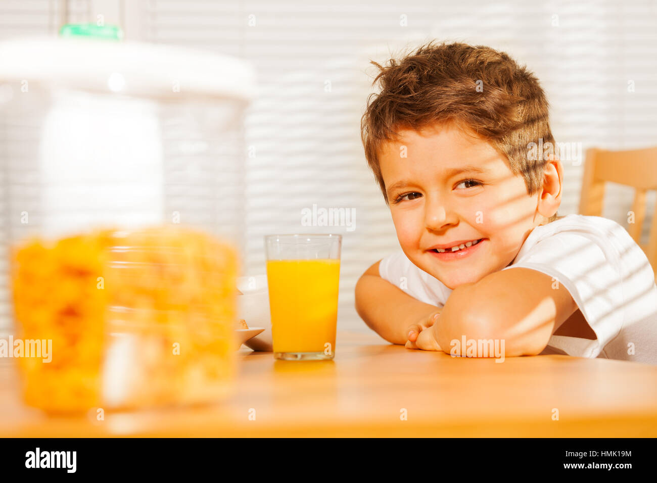 Happy smiling boy having healthy breakfast Stock Photo - Alamy