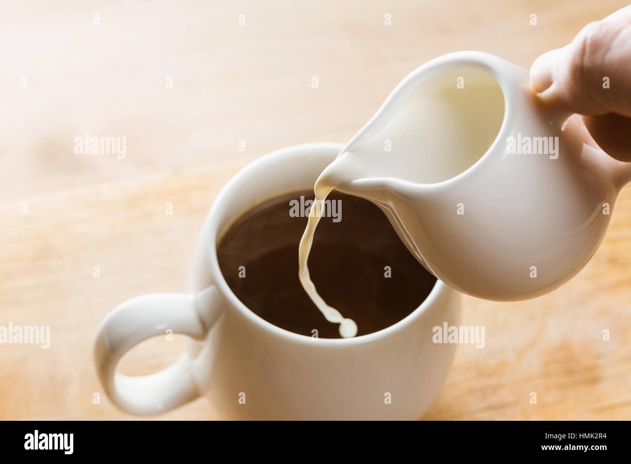 Closeup Pouring Cream into Cup of Hot Coffee Stock Photo - Alamy