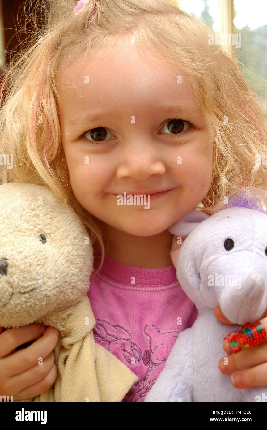 Little girl with toys Stock Photo - Alamy