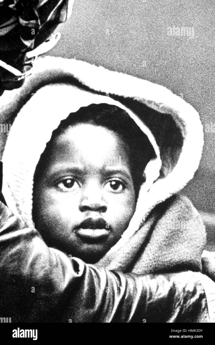 Dark skinned child with sad look Stock Photo - Alamy