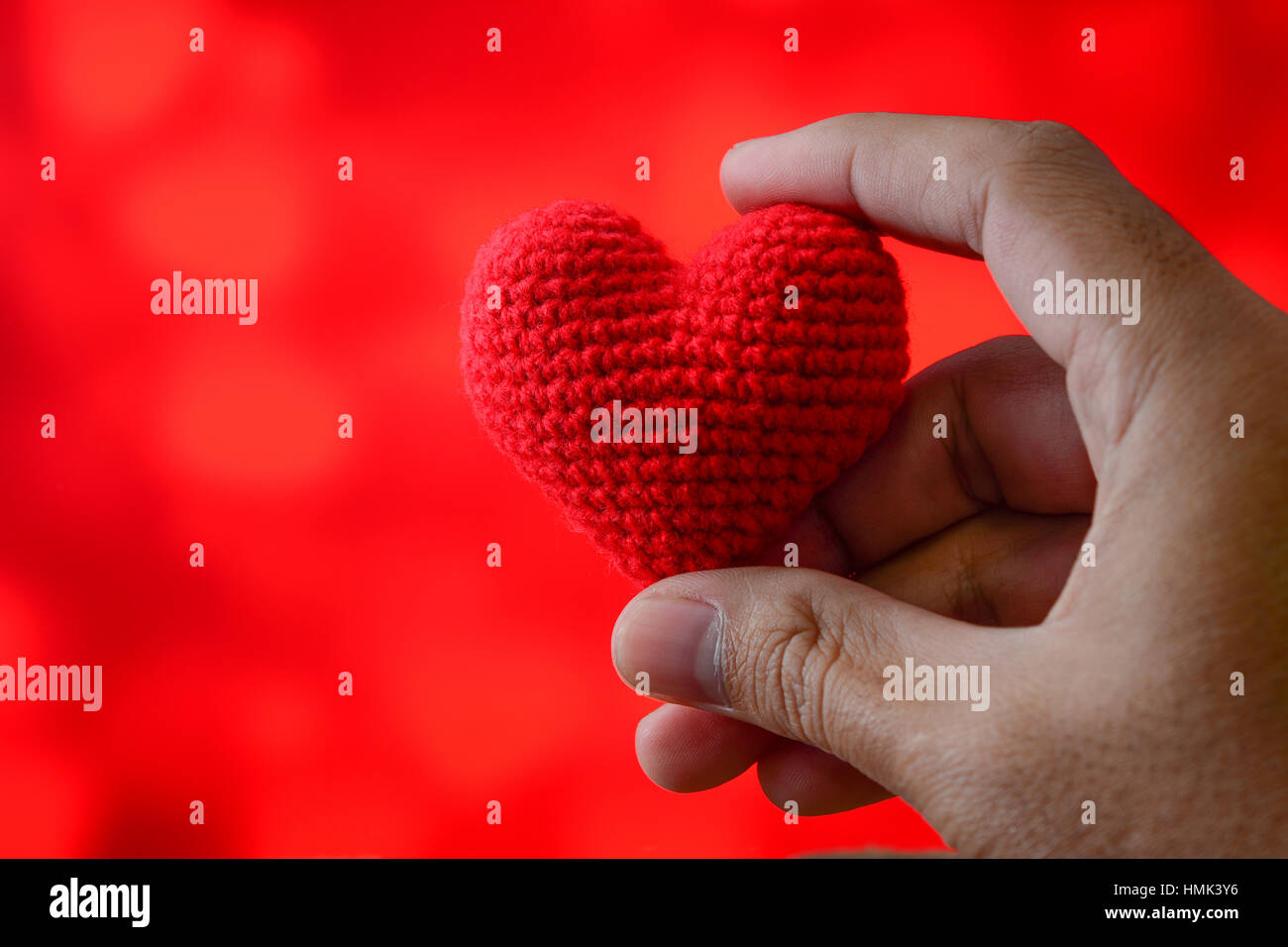 Pick red heart with beautiful red background Stock Photo - Alamy