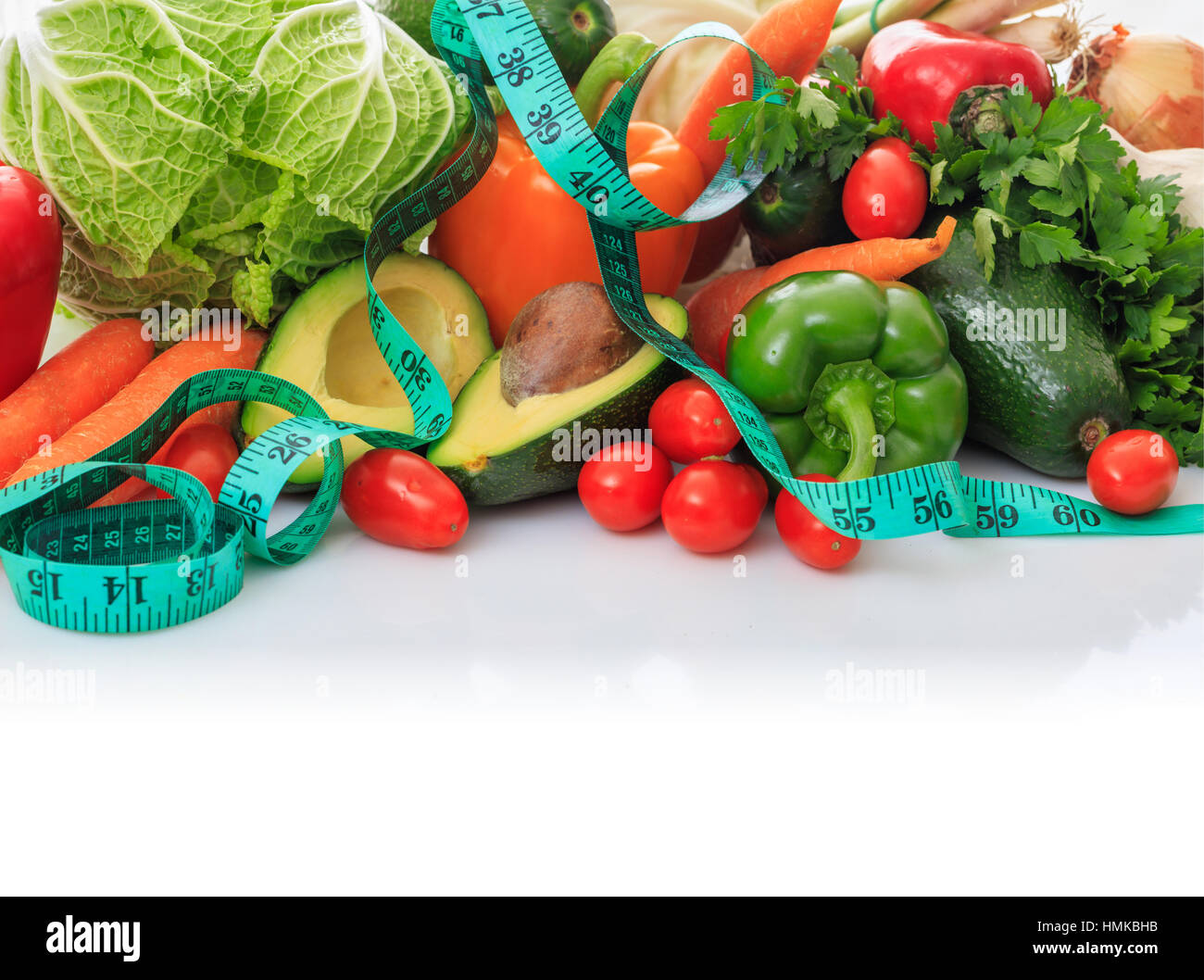 Variety of fresh vegetables and measure tape on white background Stock ...