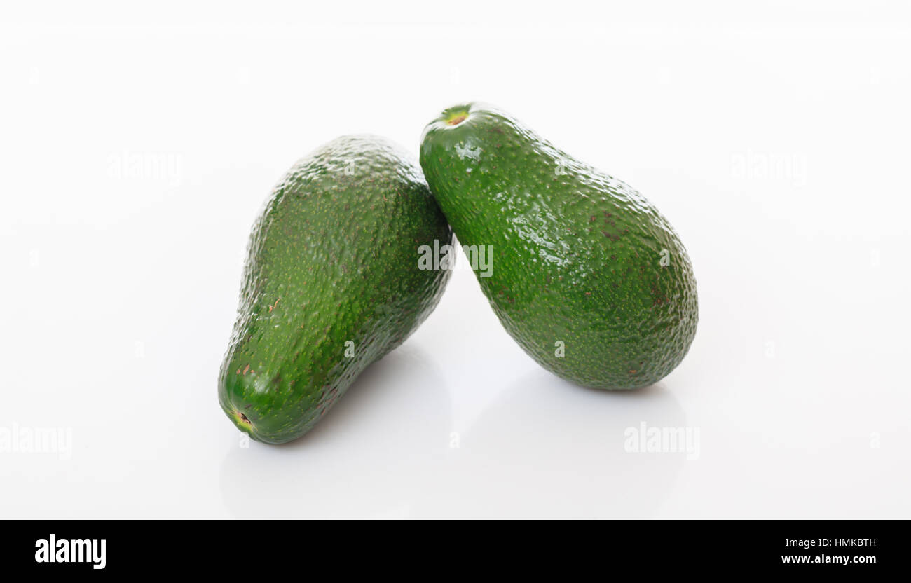 Two avocados isolated on white background Stock Photo - Alamy