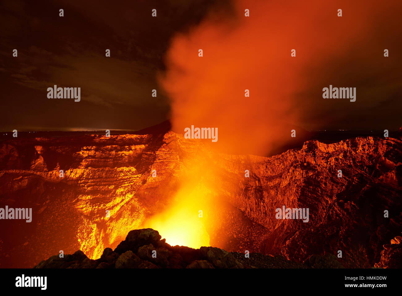 orange glow coming from volcano crater at night Stock Photo - Alamy