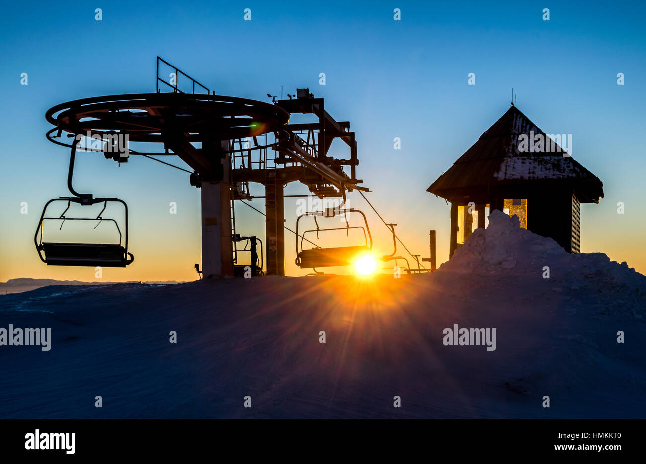 Chair ski lift upper end at sunset Stock Photo - Alamy