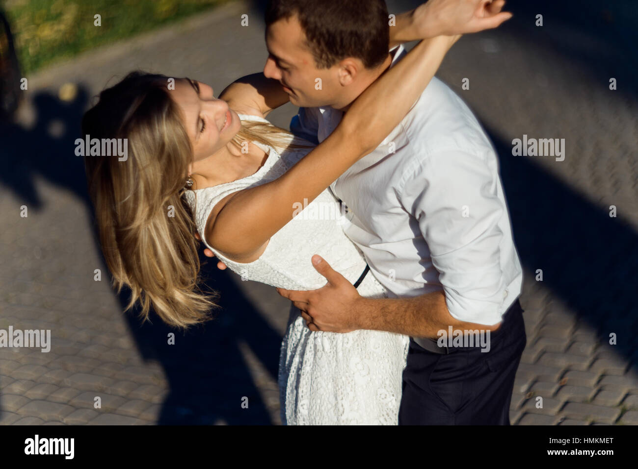 Young people embracing Stock Photo - Alamy