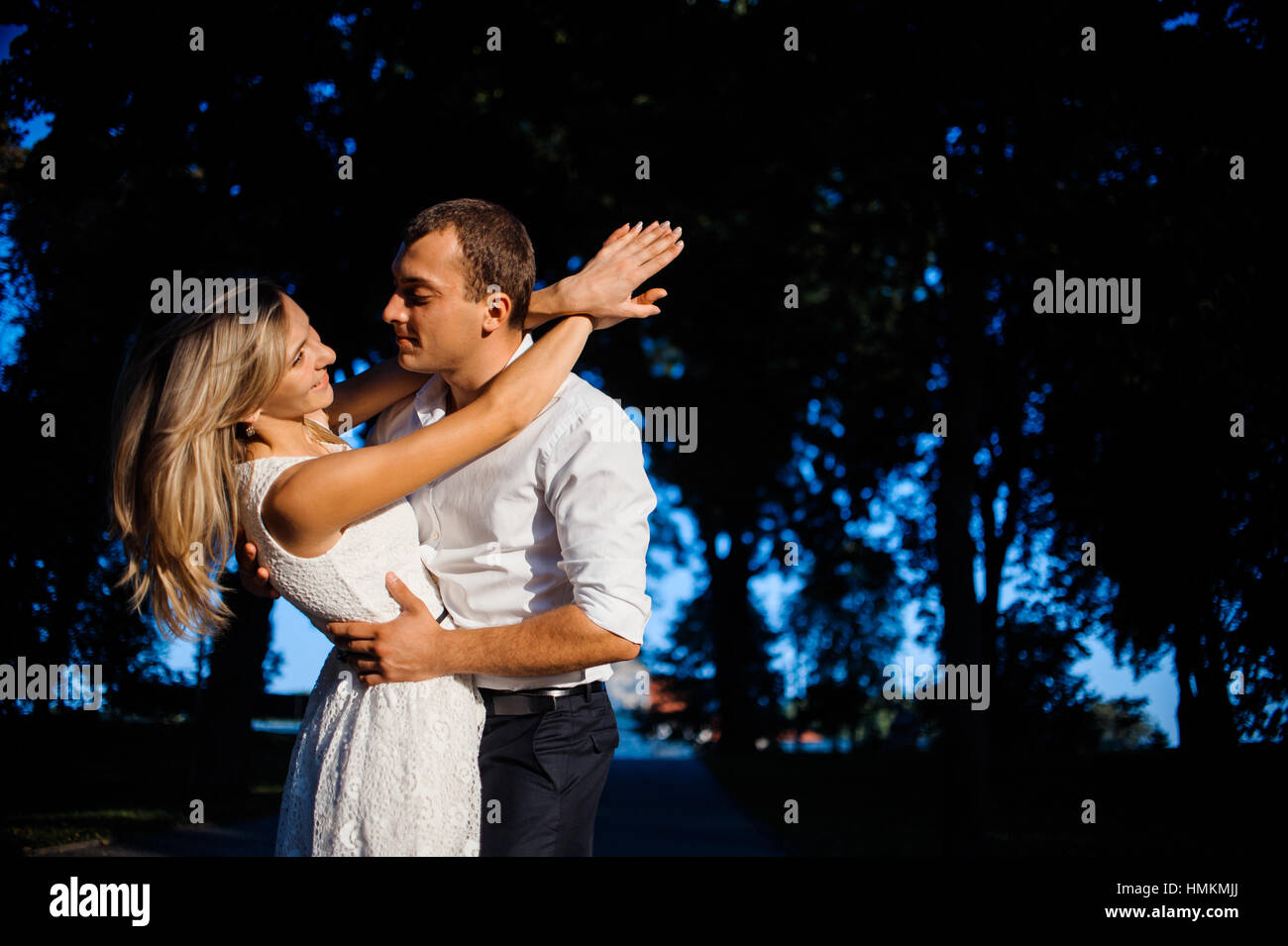 Young people embracing Stock Photo - Alamy
