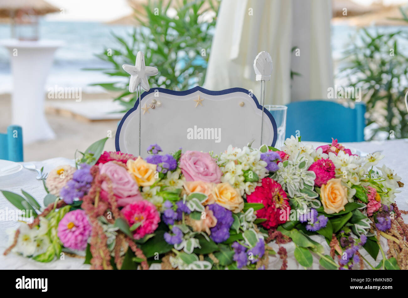 A white card Just married sign on table with flowers at a beach wedding ...