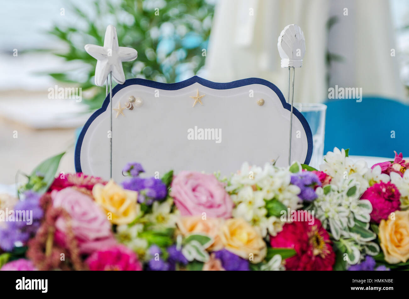 A white card Just married sign on table with flowers at a beach wedding ...