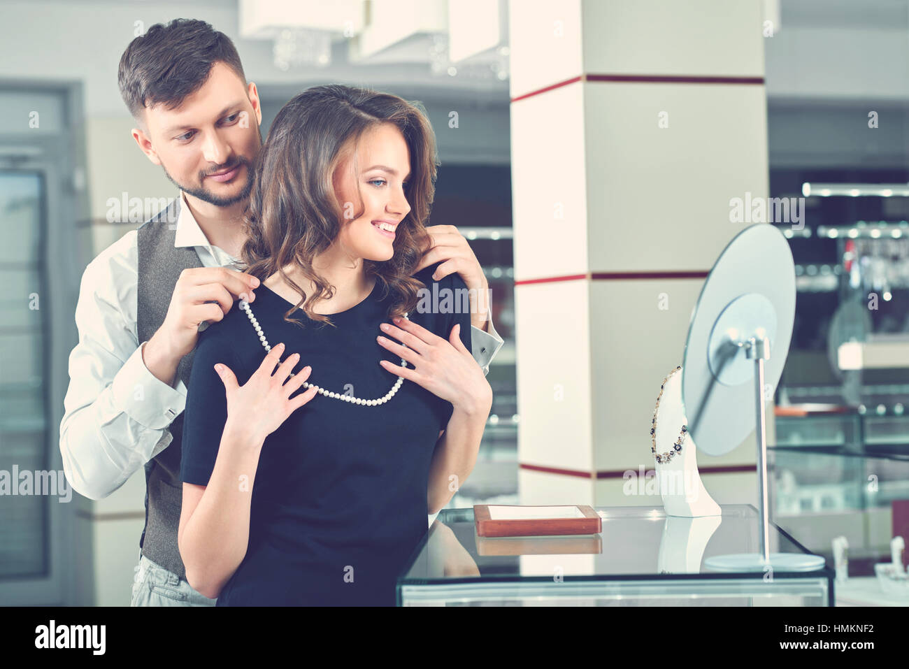 Man trying pearl necklace for gorgeous girl Stock Photo - Alamy