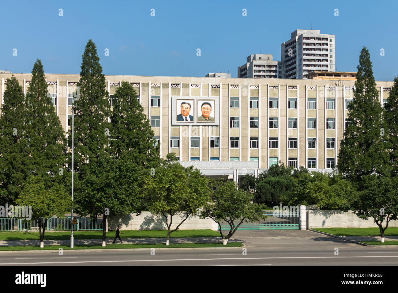 house on a street in Pyongyang with portraits of Kim Il Sung and Kim ...