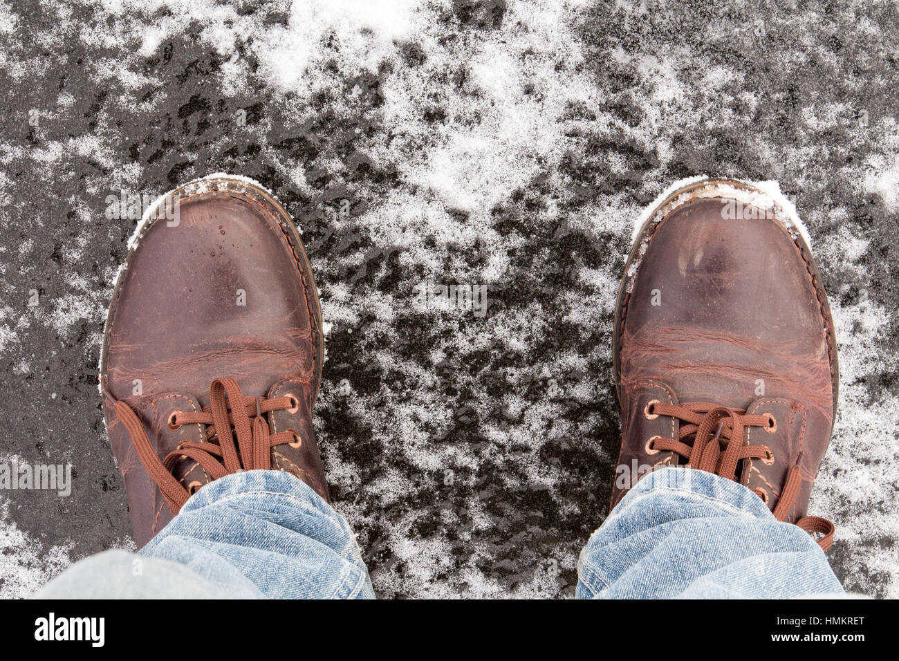 Male legs in leather shoes standing on frozen lake ice Stock Photo - Alamy
