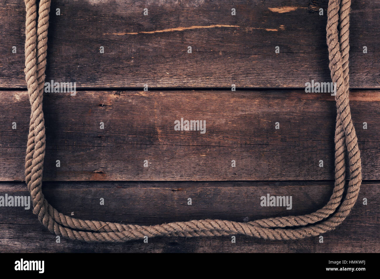 old rope on wood plank background Stock Photo - Alamy