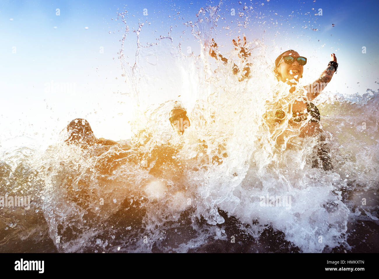 Happy friends beach sunset waves Stock Photo - Alamy