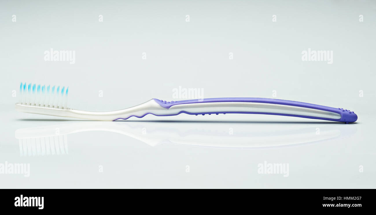 isolated one purple tooth brush on white background Stock Photo - Alamy