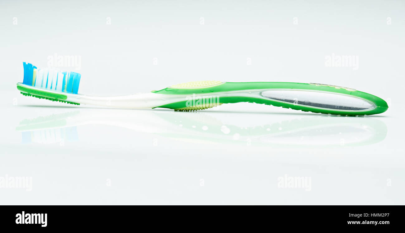 green tooth brush isolated on white background Stock Photo - Alamy