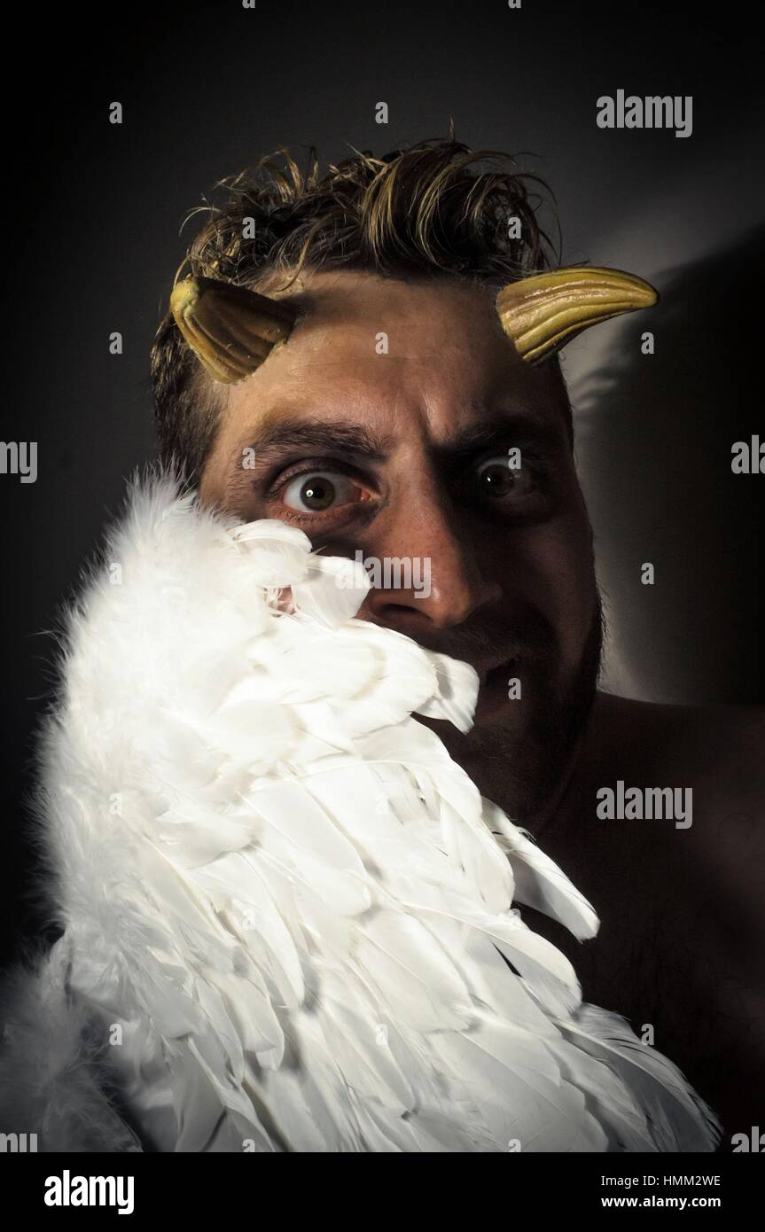 Fallen angel satan with feathered wings and moody lighting Stock Photo ...