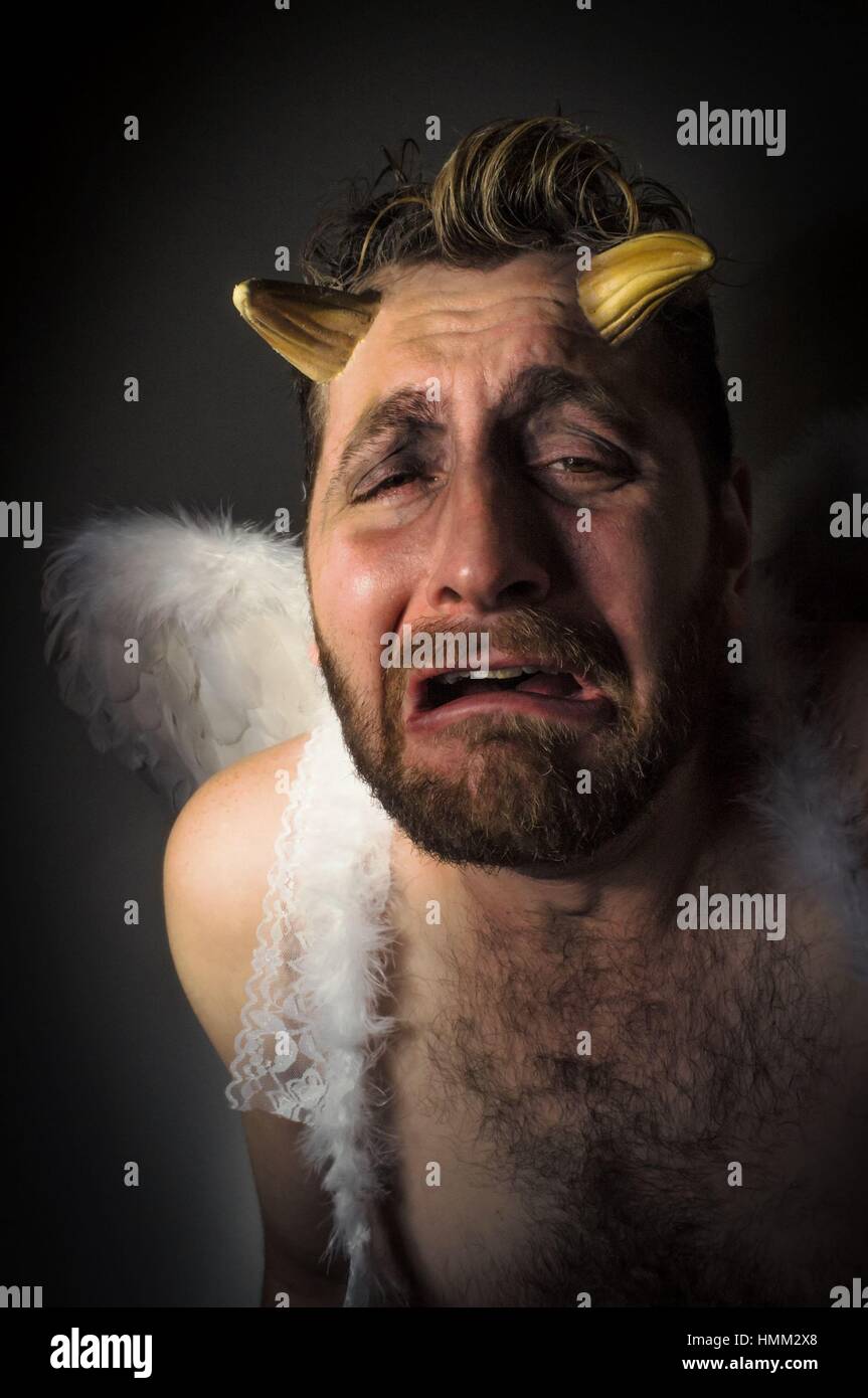 Fallen angel satan with feathered wings and moody lighting Stock Photo ...