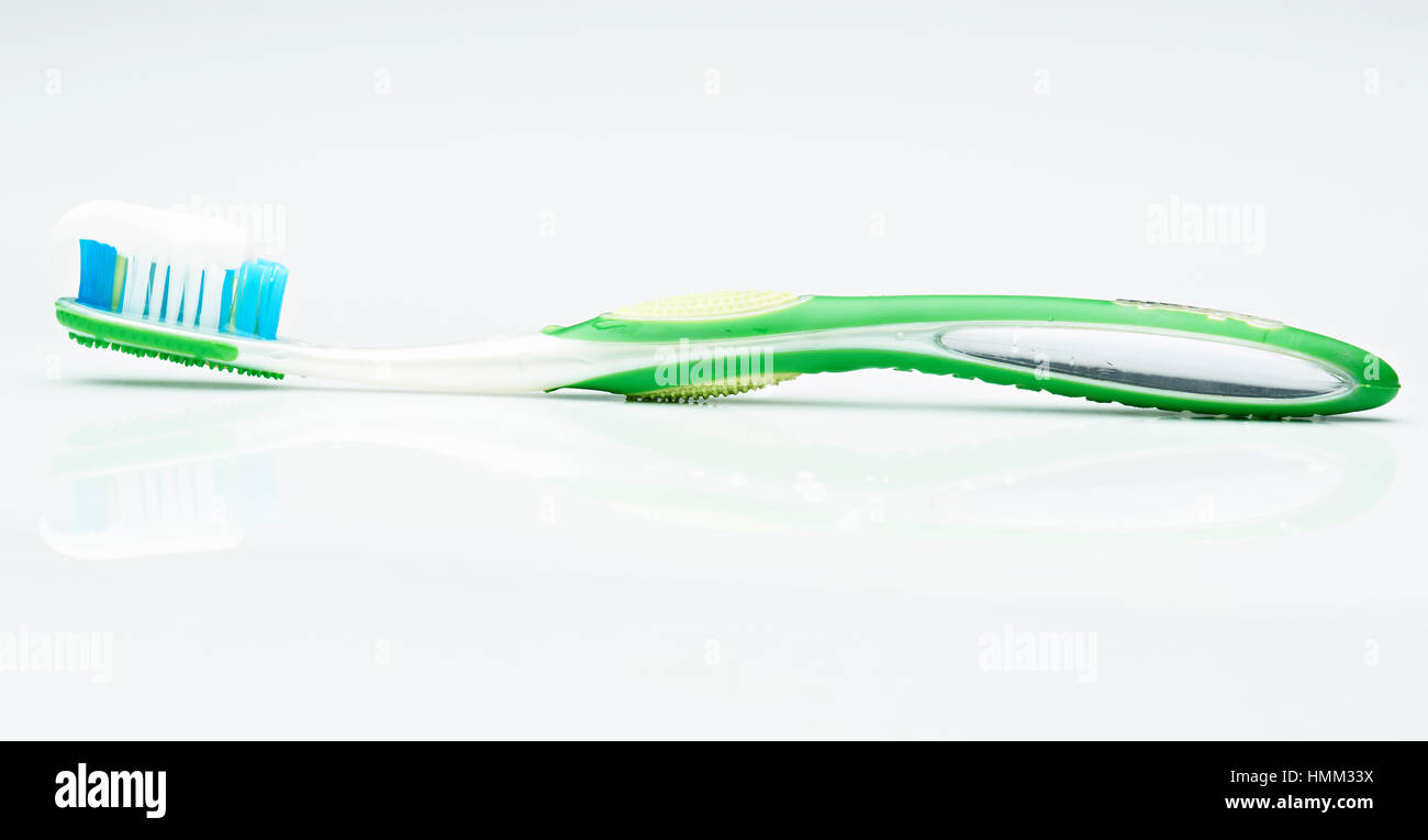green tooth brush with white paste isolated Stock Photo - Alamy
