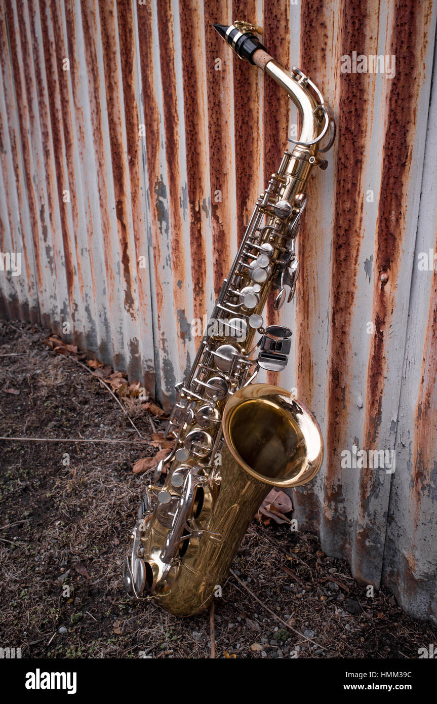 Jazz musical instrument saxophone with rusty fence background Stock ...