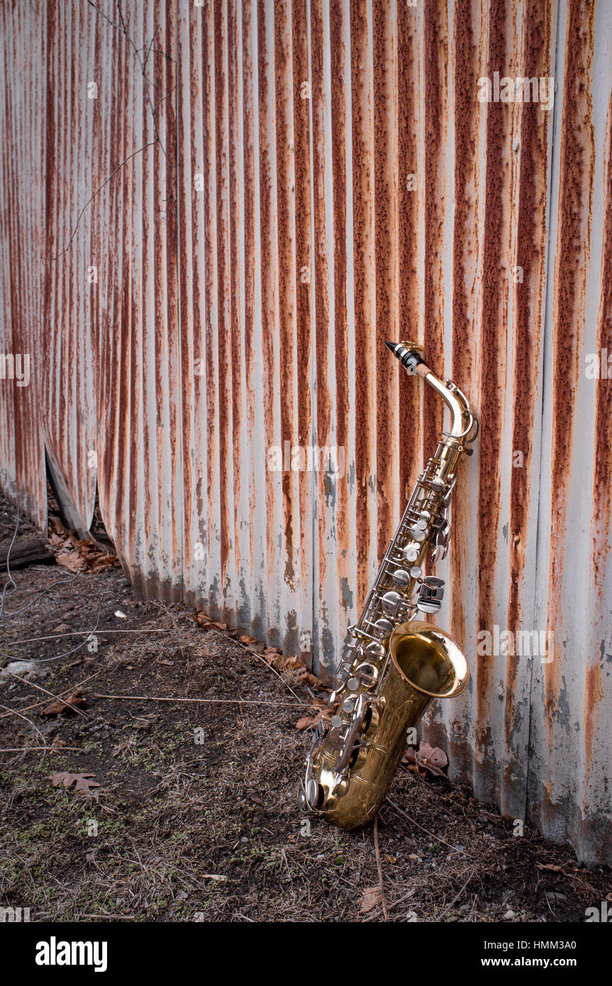 Jazz musical instrument saxophone with rusty fence background Stock ...