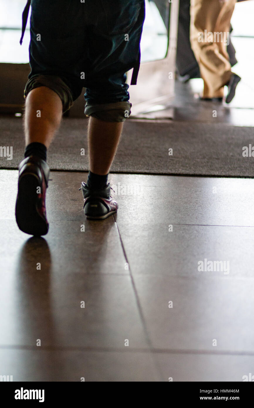 boots and legs of passing by people on the pavement Stock Photo - Alamy