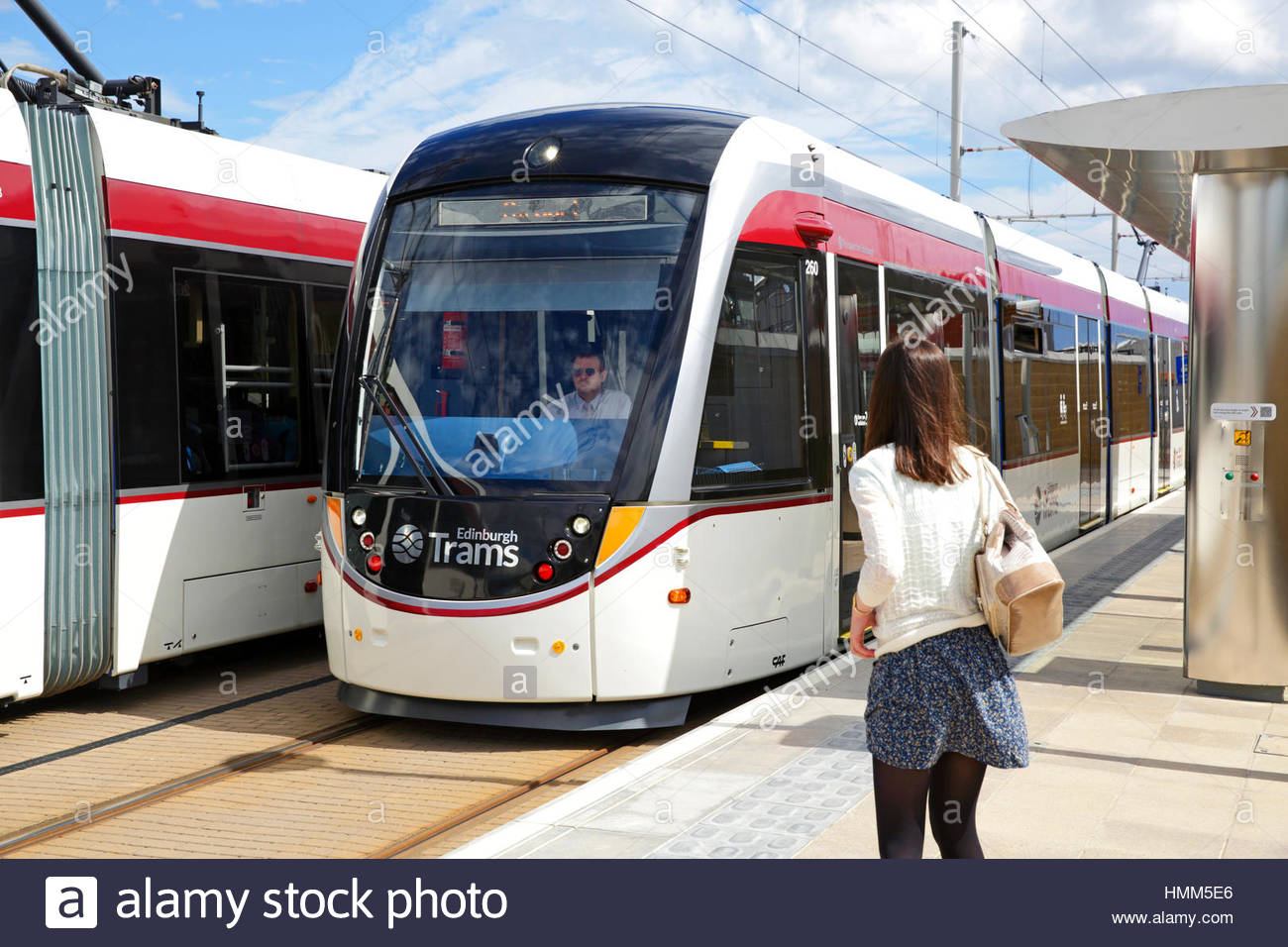 Passenger about to board Edinburgh tram at Murrayfield stadium station ...