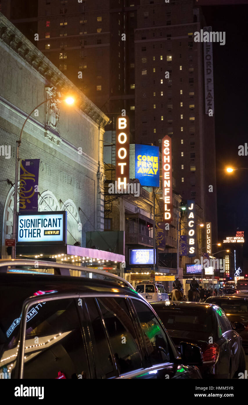 A line of lighted theater marquees on West 45th Street in New York City ...