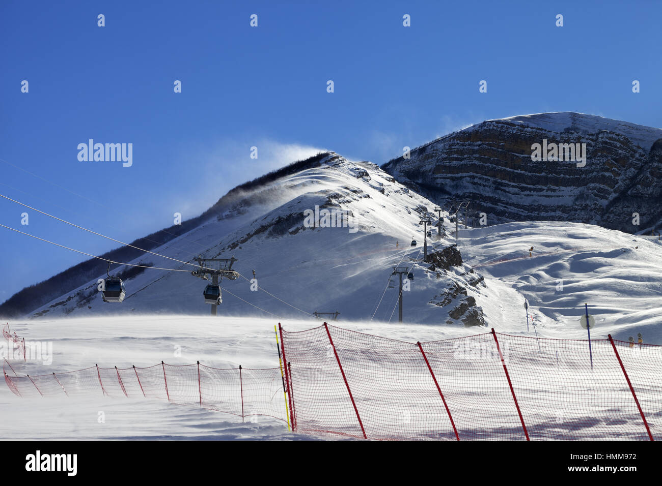 Gondola lift on ski resort at windy winter day. Greater Caucasus, Mount ...