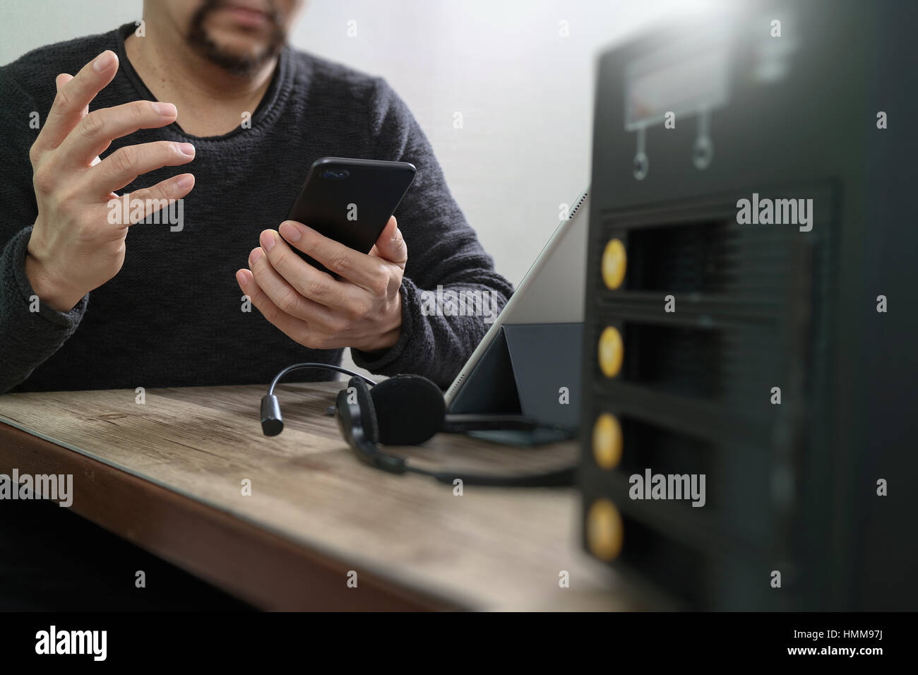 man hand using VOIP headset with digital tablet computer docking ...