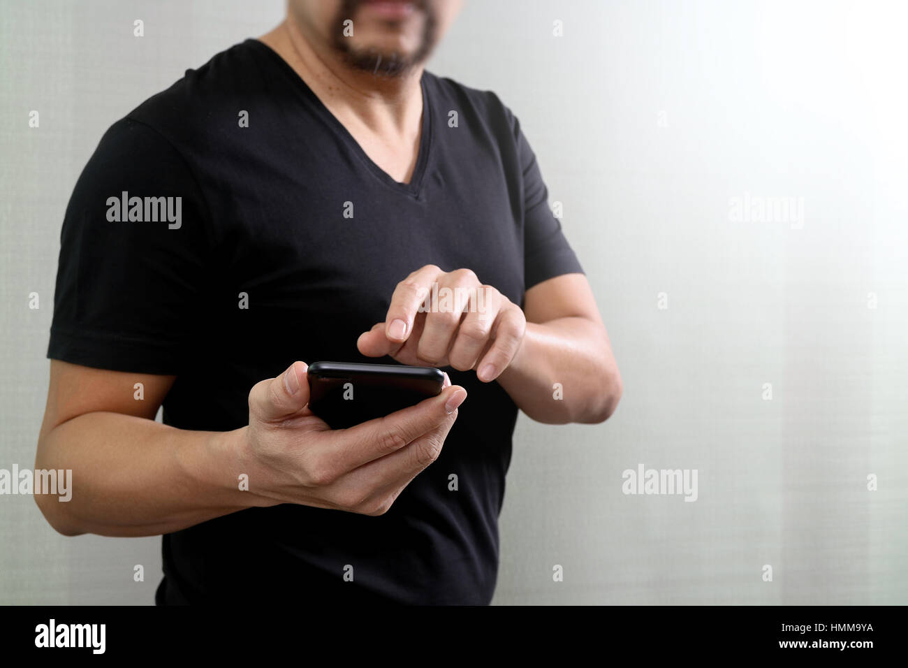 Designer hand using smart phone for mobile payments online shopping ...