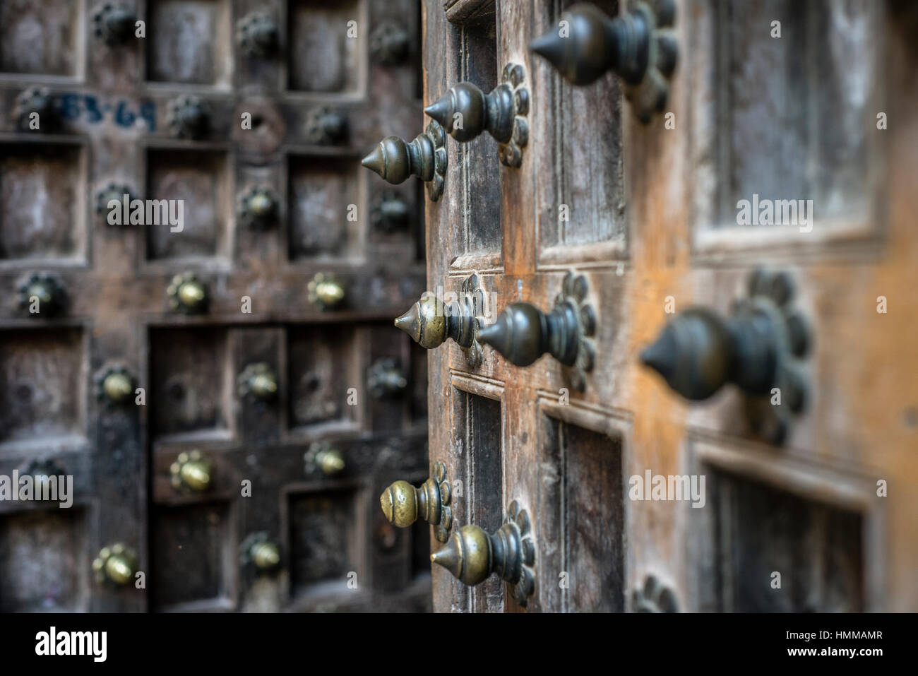 Wooden door with pointed brass pommels of a building in Stone Town ...