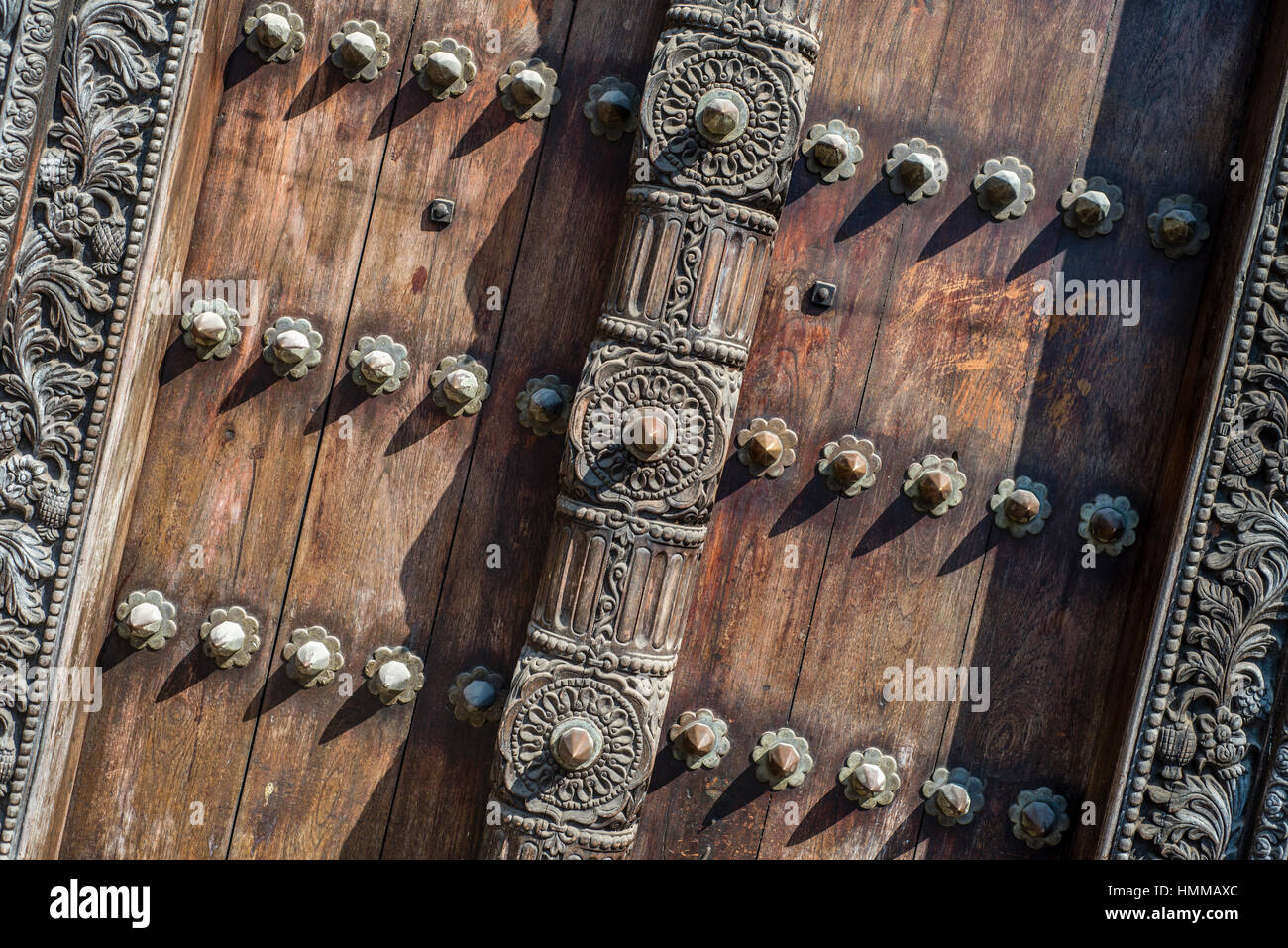 Wooden door with pointed brass pommels of a building in Stone Town ...