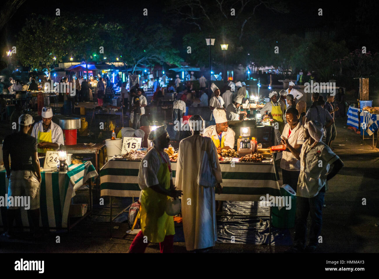 Chefs prepare dishes during the Night food market at Forodhani Gardens ...