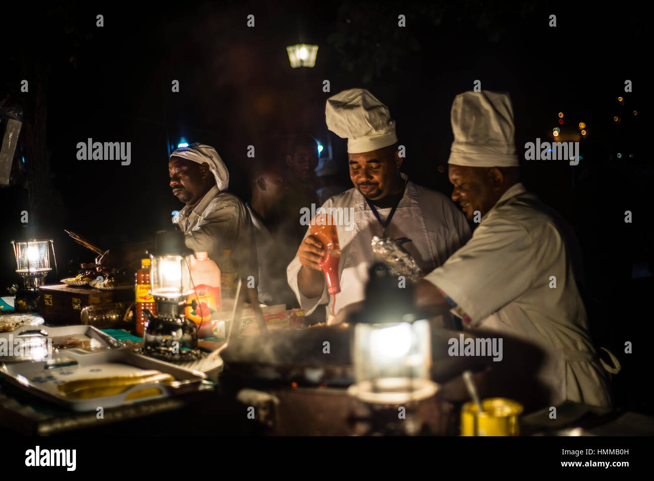 Chefs prepare dishes during the Night food market at Forodhani Gardens ...