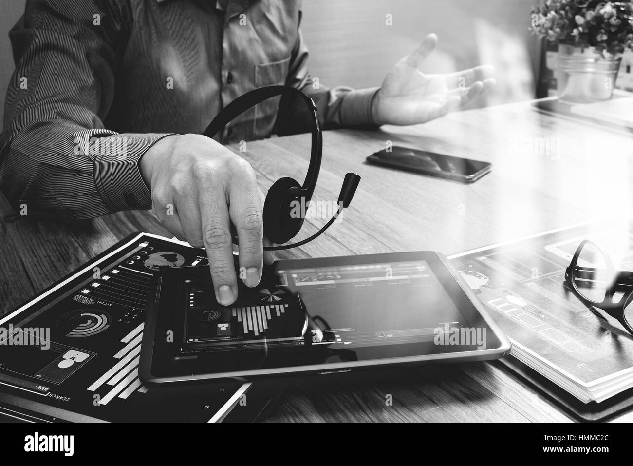Businessman hand using VOIP headset with digital tablet computer ...