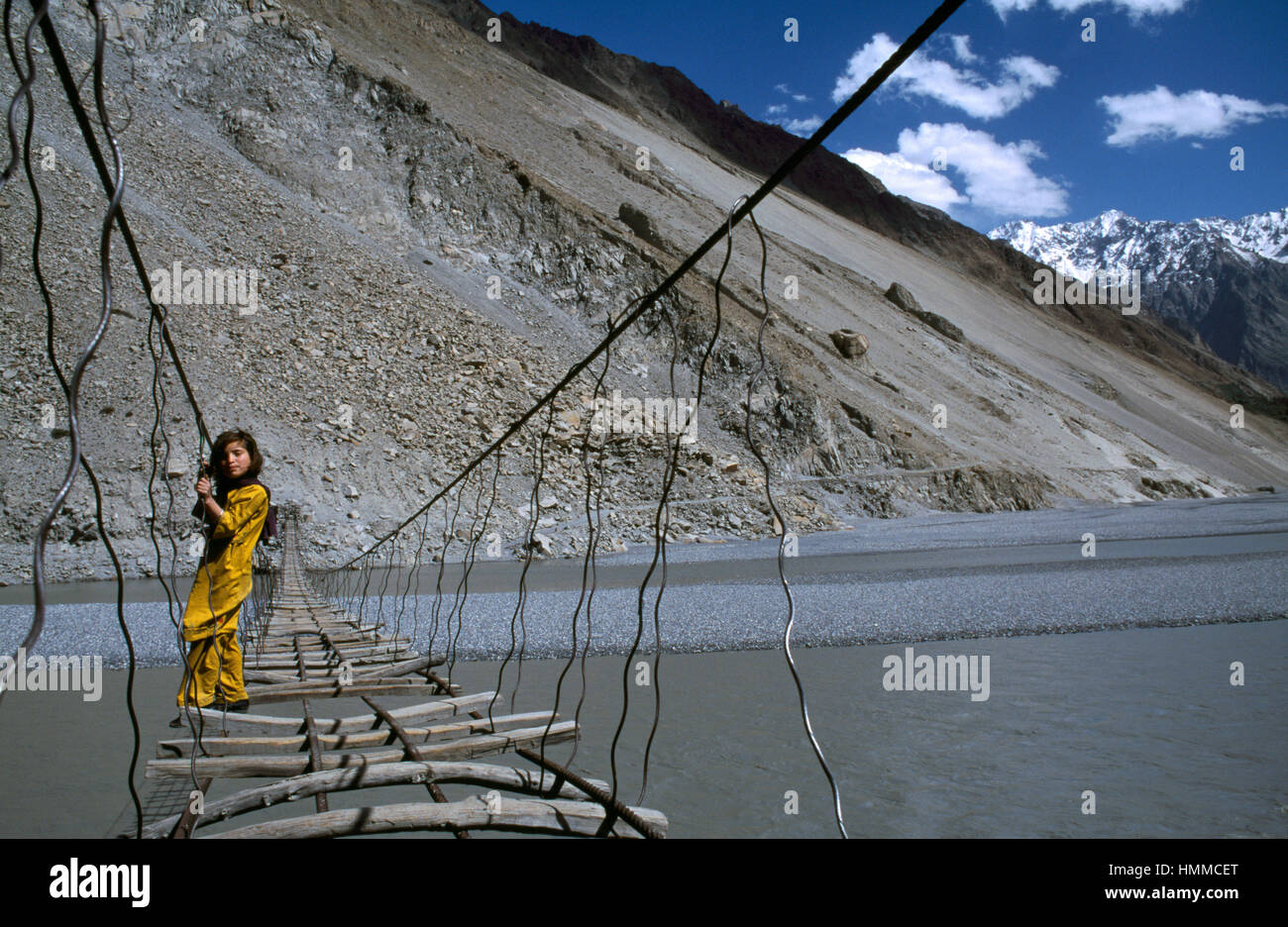 Girl on suspension bridge at Passu village, Upper Hunza valley ...