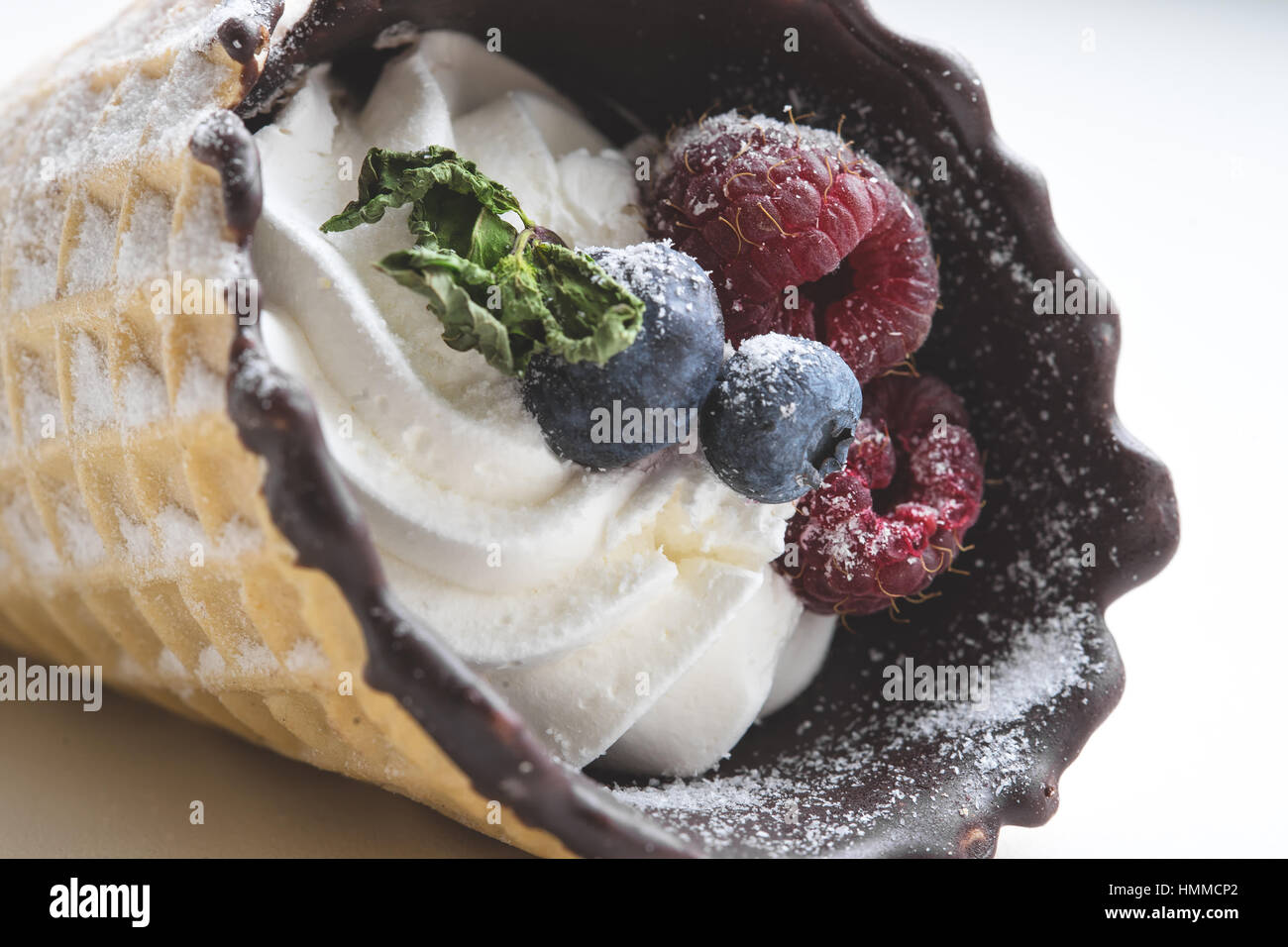 Ice cream with berry in ice cream cone. Homemade berry ice cream cones ...