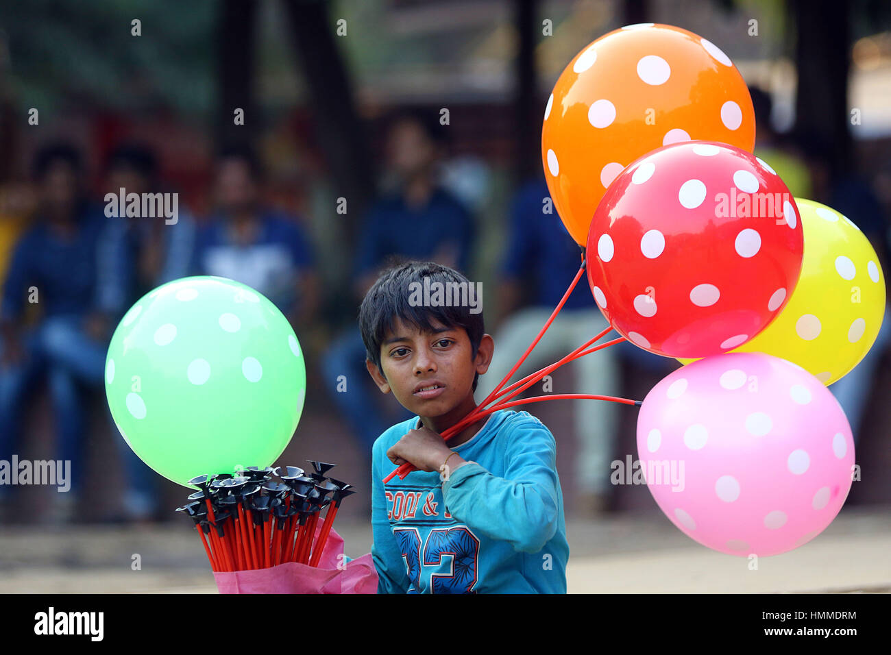 Street child take a rest from selling balloons in Dhaka Stock Photo - Alamy