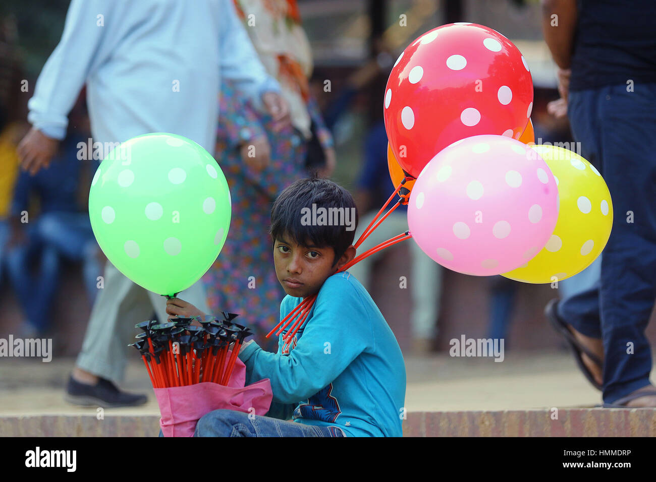Street child take a rest from selling balloons in Dhaka Stock Photo - Alamy