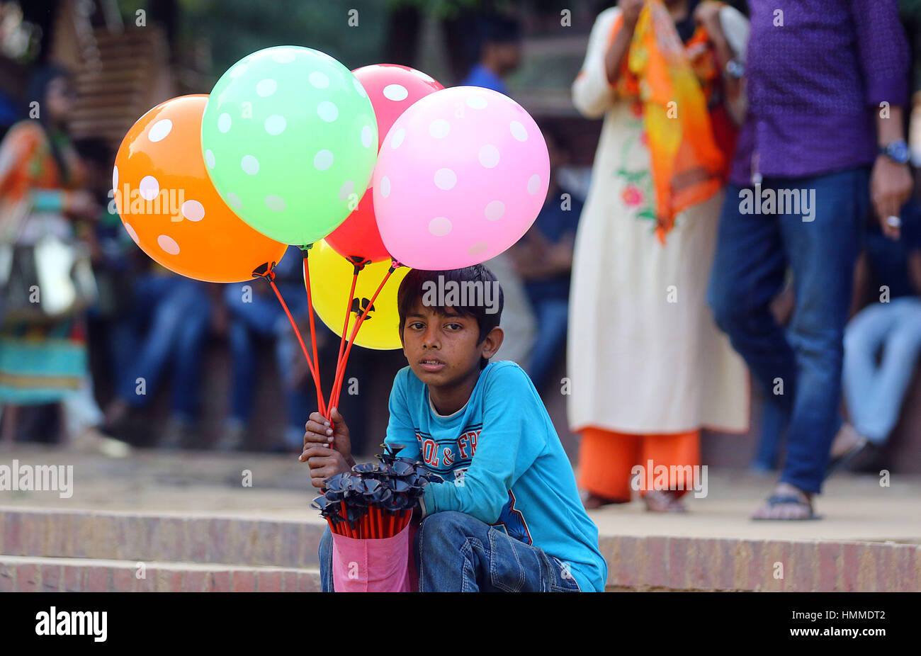 Street child take a rest from selling balloons in Dhaka Stock Photo - Alamy
