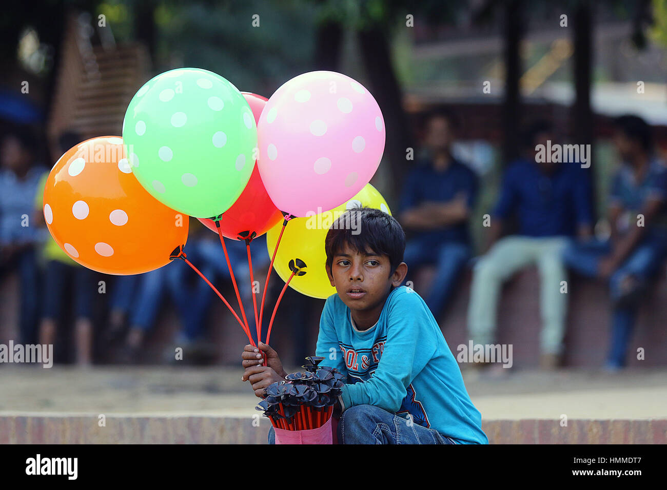Street child take a rest from selling balloons in Dhaka Stock Photo - Alamy