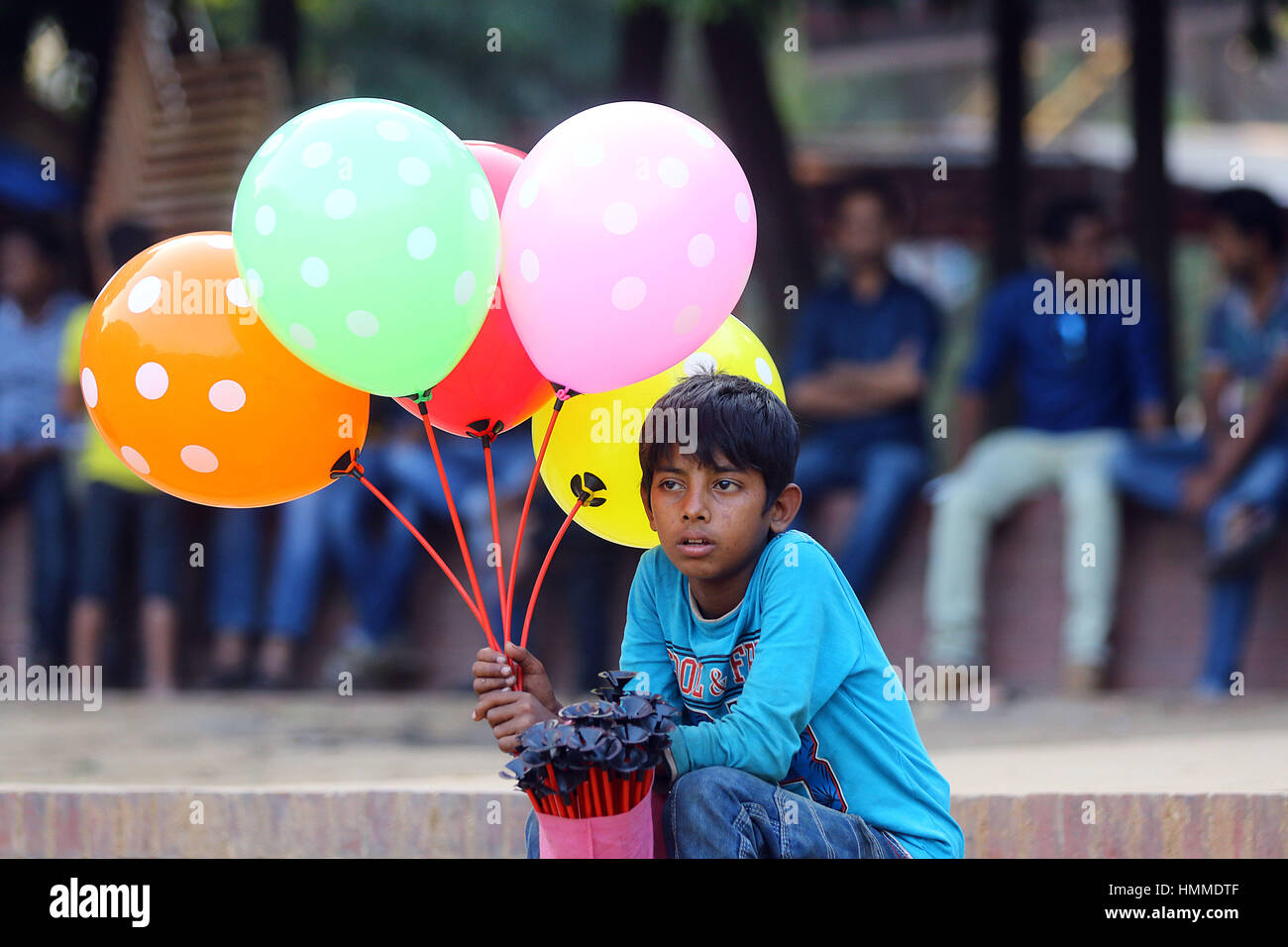 Street child take a rest from selling balloons in Dhaka Stock Photo - Alamy