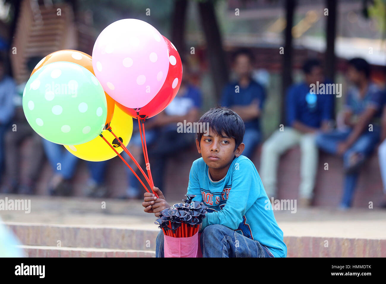 Street child take a rest from selling balloons in Dhaka Stock Photo - Alamy