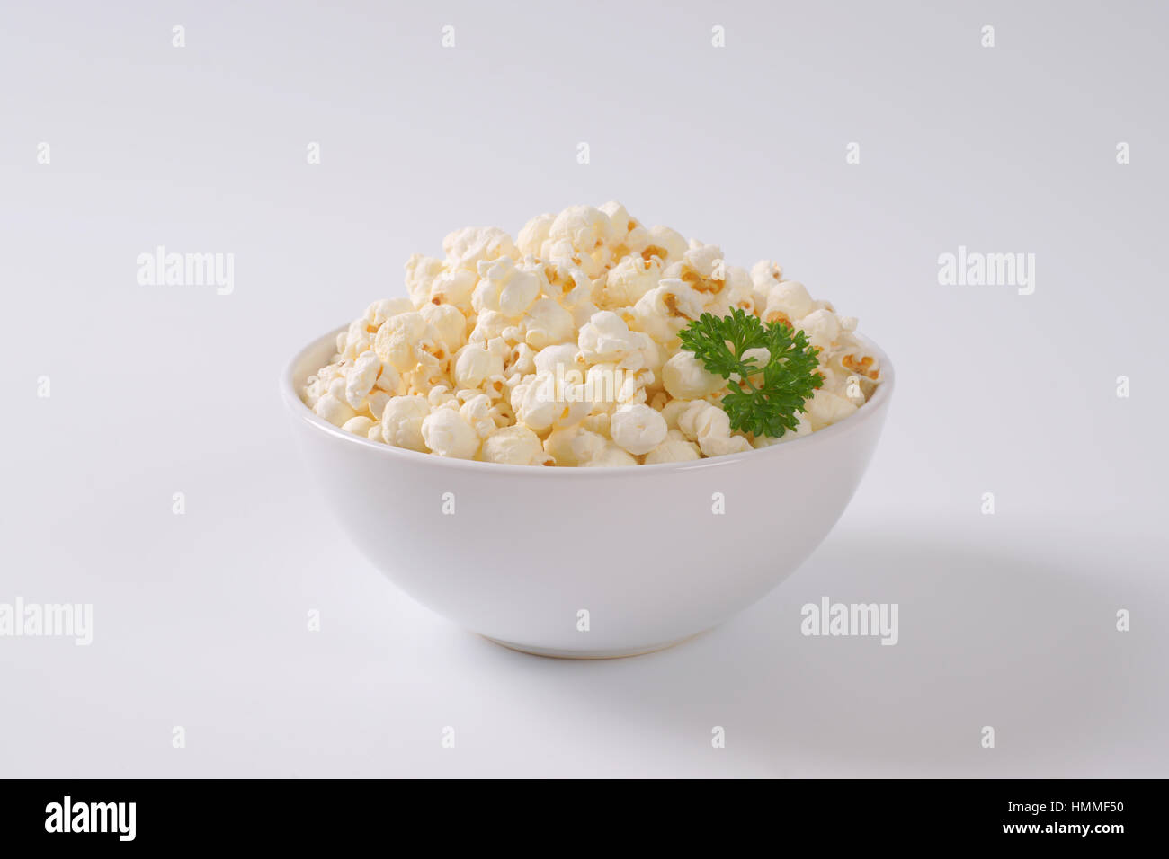 bowl of fresh popcorn on off-white background with shadows Stock Photo ...