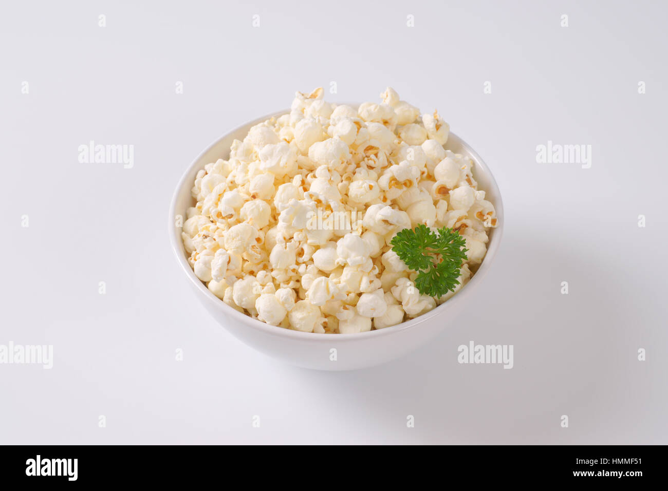 bowl of fresh popcorn on off-white background with shadows Stock Photo ...