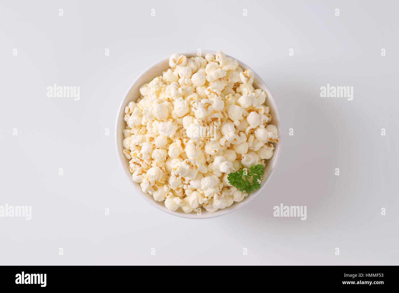 bowl of fresh popcorn on off-white background with shadows Stock Photo ...