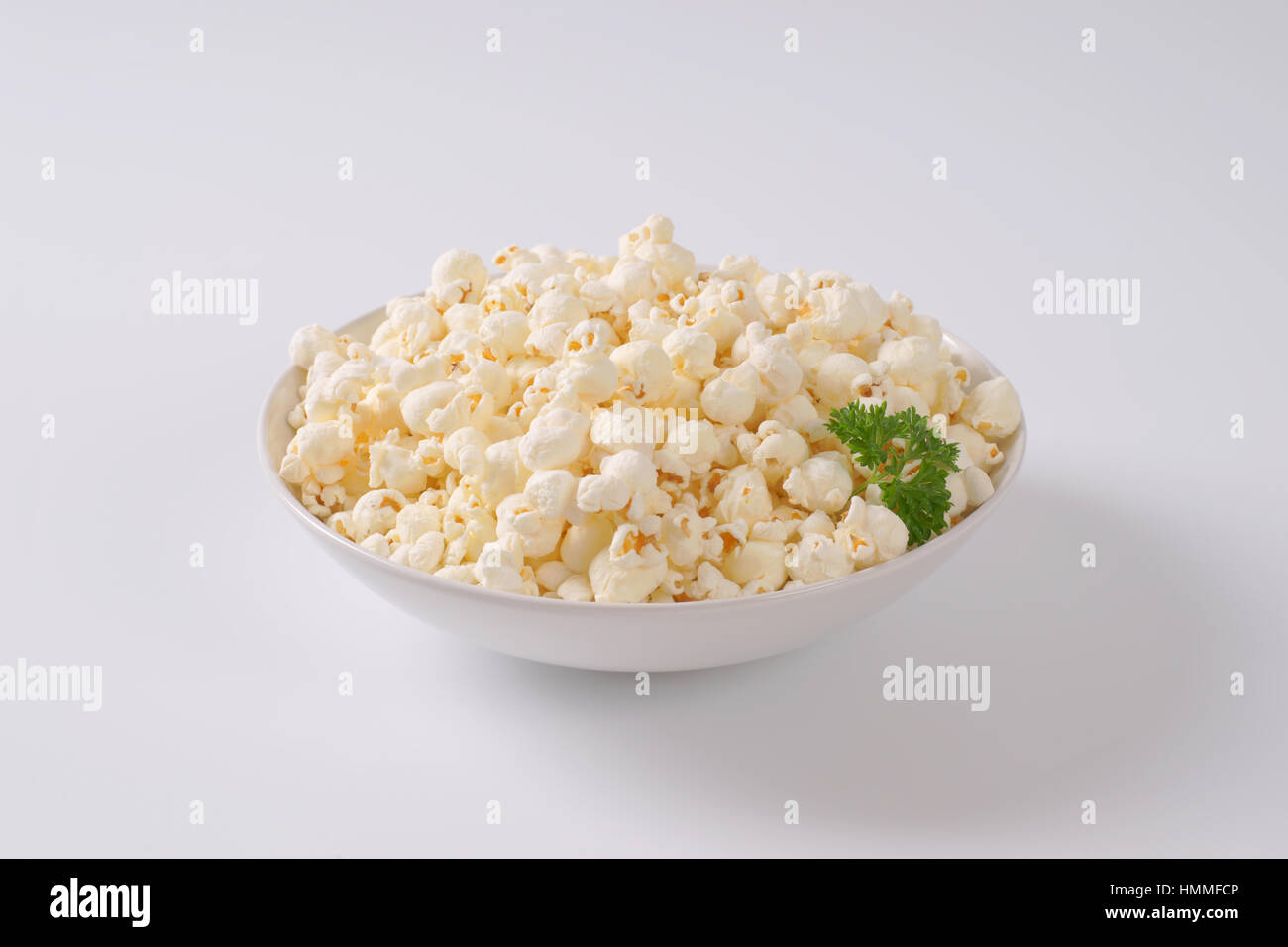 bowl of fresh popcorn on off-white background with shadows Stock Photo ...